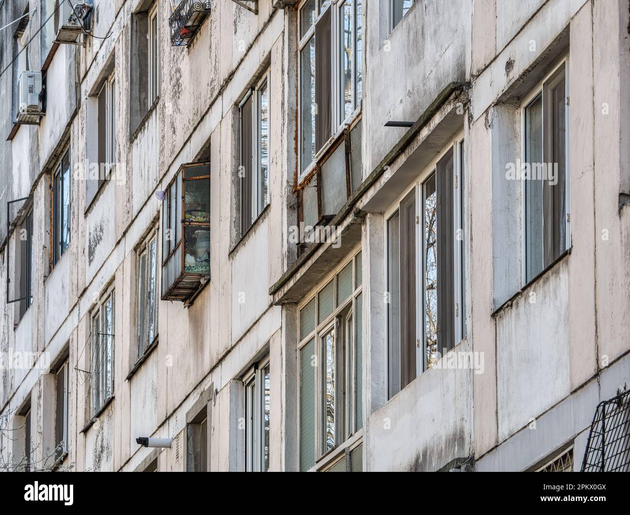 Worn out apartment building from the communist era against blue sky in ...