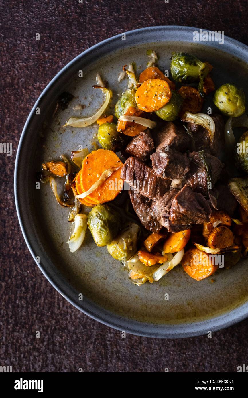 Beef stew with sweet potato and brussels sprouts Stock Photo - Alamy