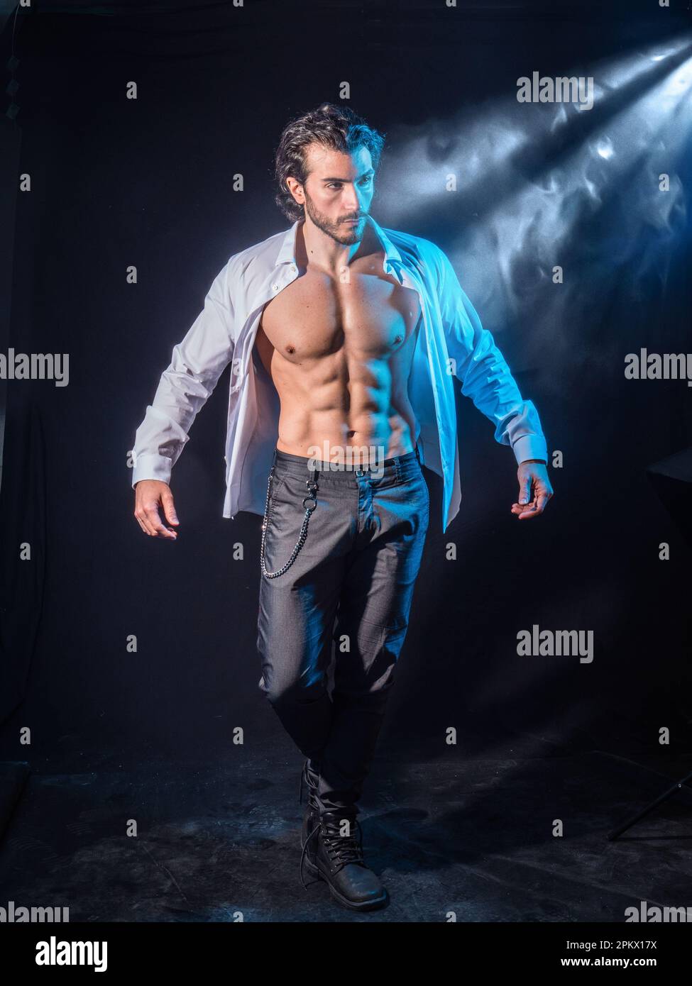 Confident, attractive young man with open shirt on muscular chest Stock ...
