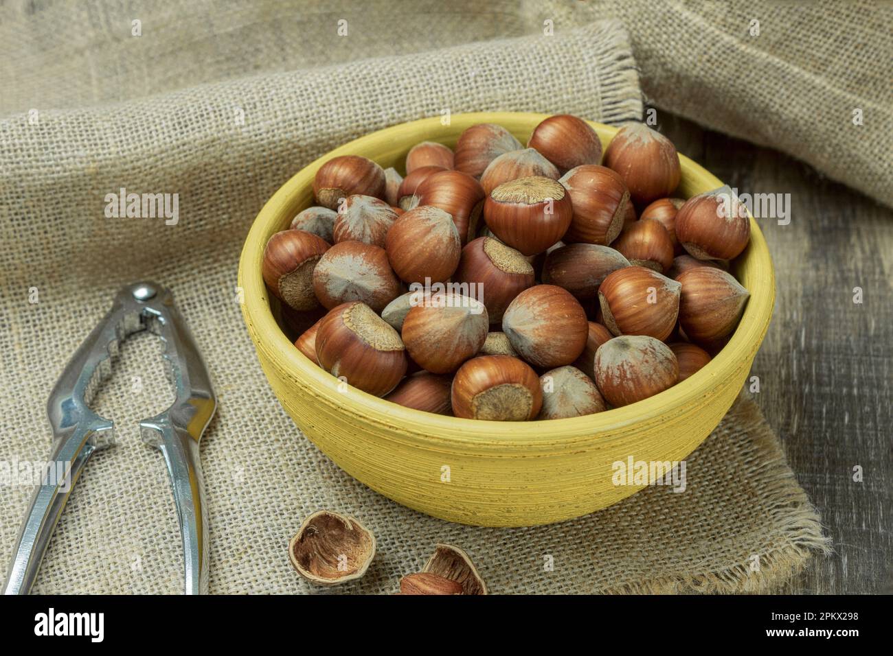 A mix of nuts in a shell, in a clay plate. A mixture of nuts on an old ...