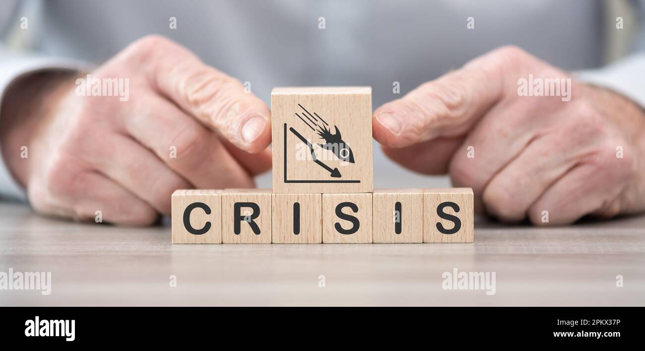 Wooden blocks with symbol of crisis concept Stock Photo - Alamy