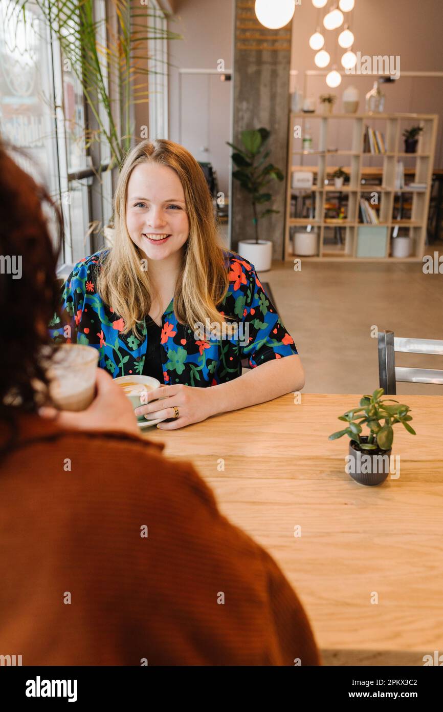 Sitting across hi-res stock photography and images - Alamy