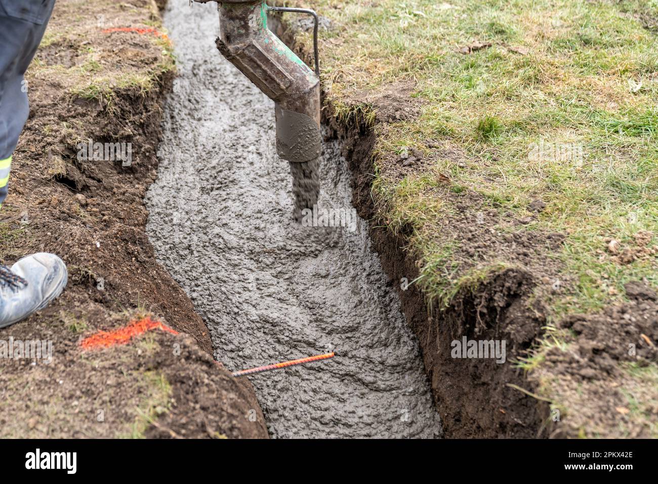 concreting from the pipe of the cement mixing car Stock Photo - Alamy