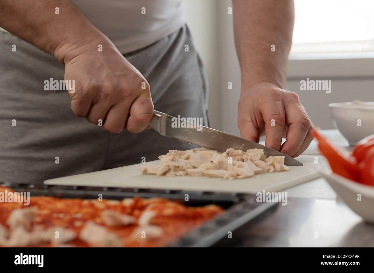 A man cuts meat. Close-up hands Stock Photo - Alamy