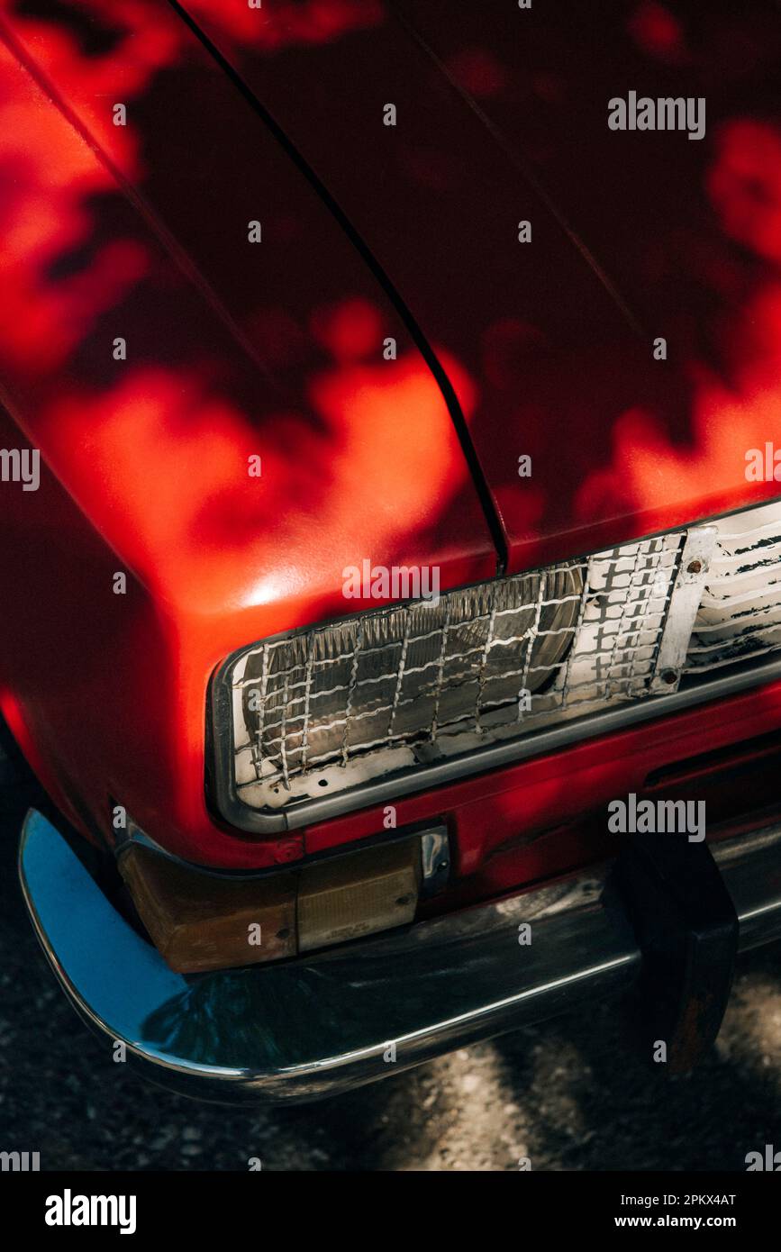 Beautiful dappled lighting on a crimson red car bonnet Stock Photo - Alamy