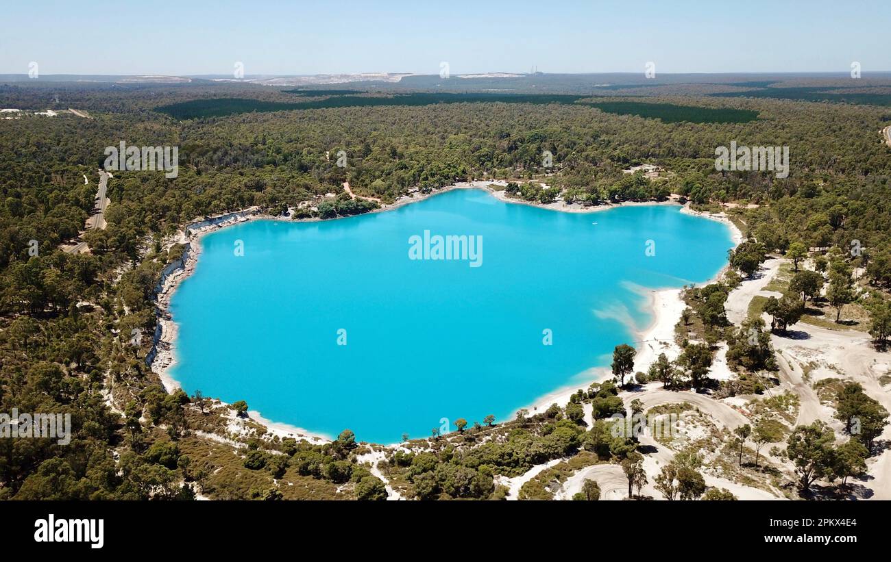 Aerial view of an artificial blue lake in Australia surrounded by bush ...