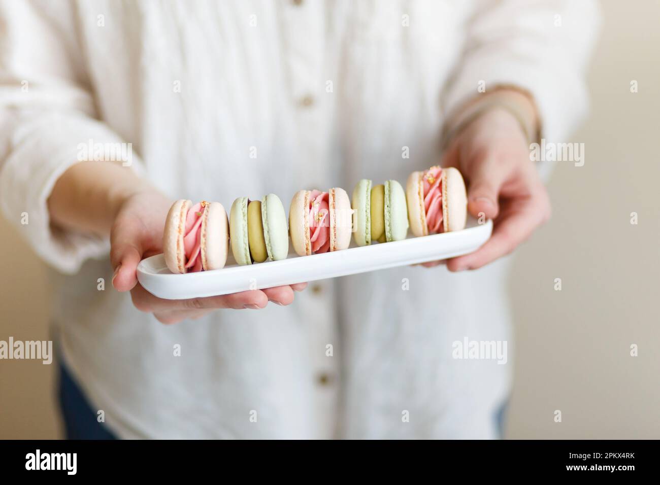Colorful fresh macaroons lie on a tray freshly prepared in the kitchen ...