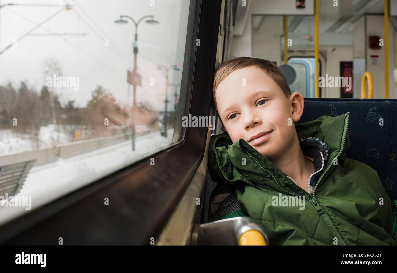 boy sitting on a trail smiling commuting to school Stock Photo - Alamy