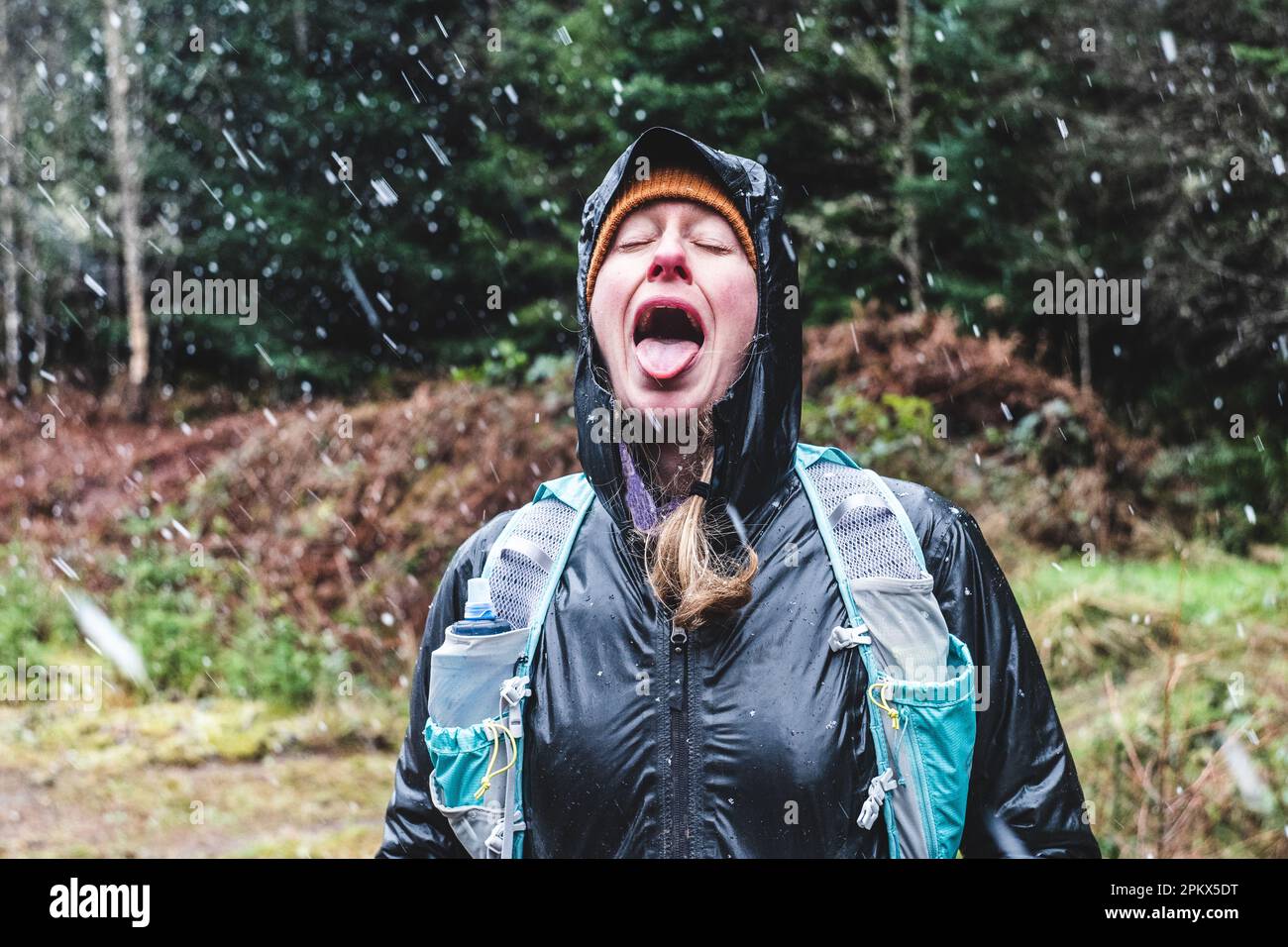 Woman with mouth open catching snow flakes on tongue Stock Photo - Alamy