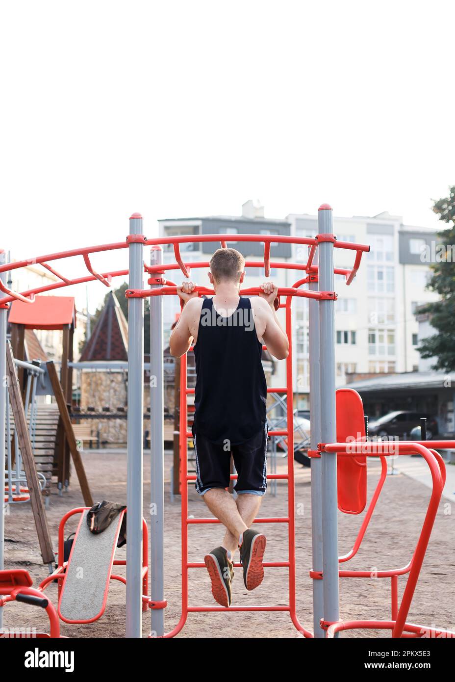 man pulls up on crossbar of sports ground alone in summer Stock Photo ...