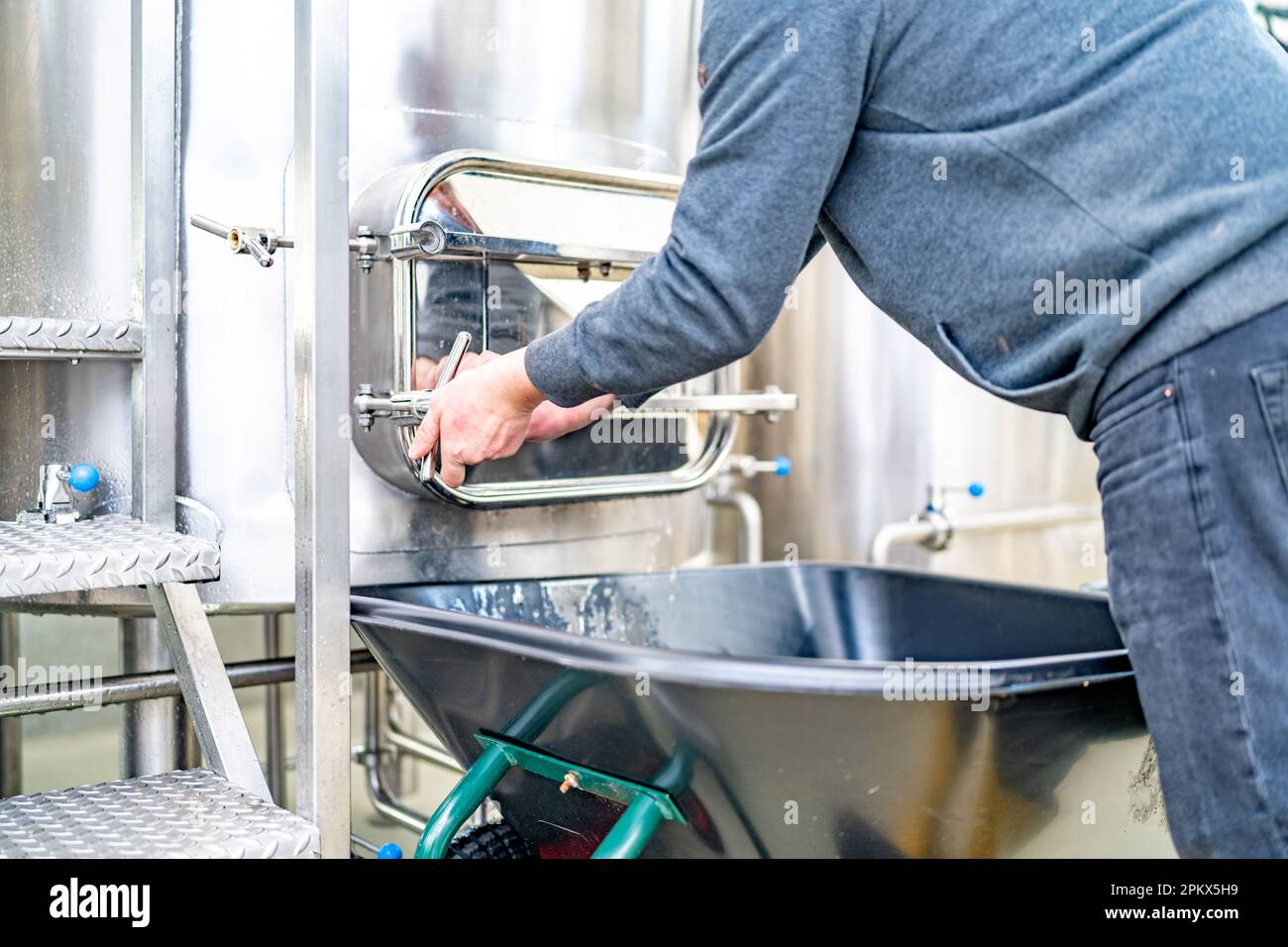 cleaning the boiler from residual malt after brewing beer in the ...