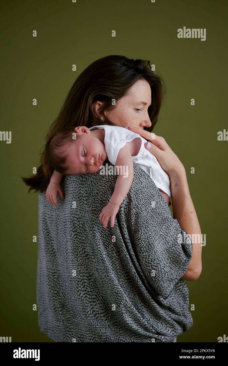 Young mum hugging sleeping newborn baby Stock Photo - Alamy
