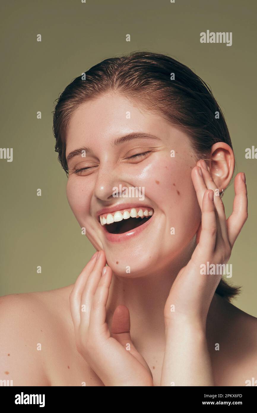 Close up model with fresh glowing skin and natural makeup on green ...