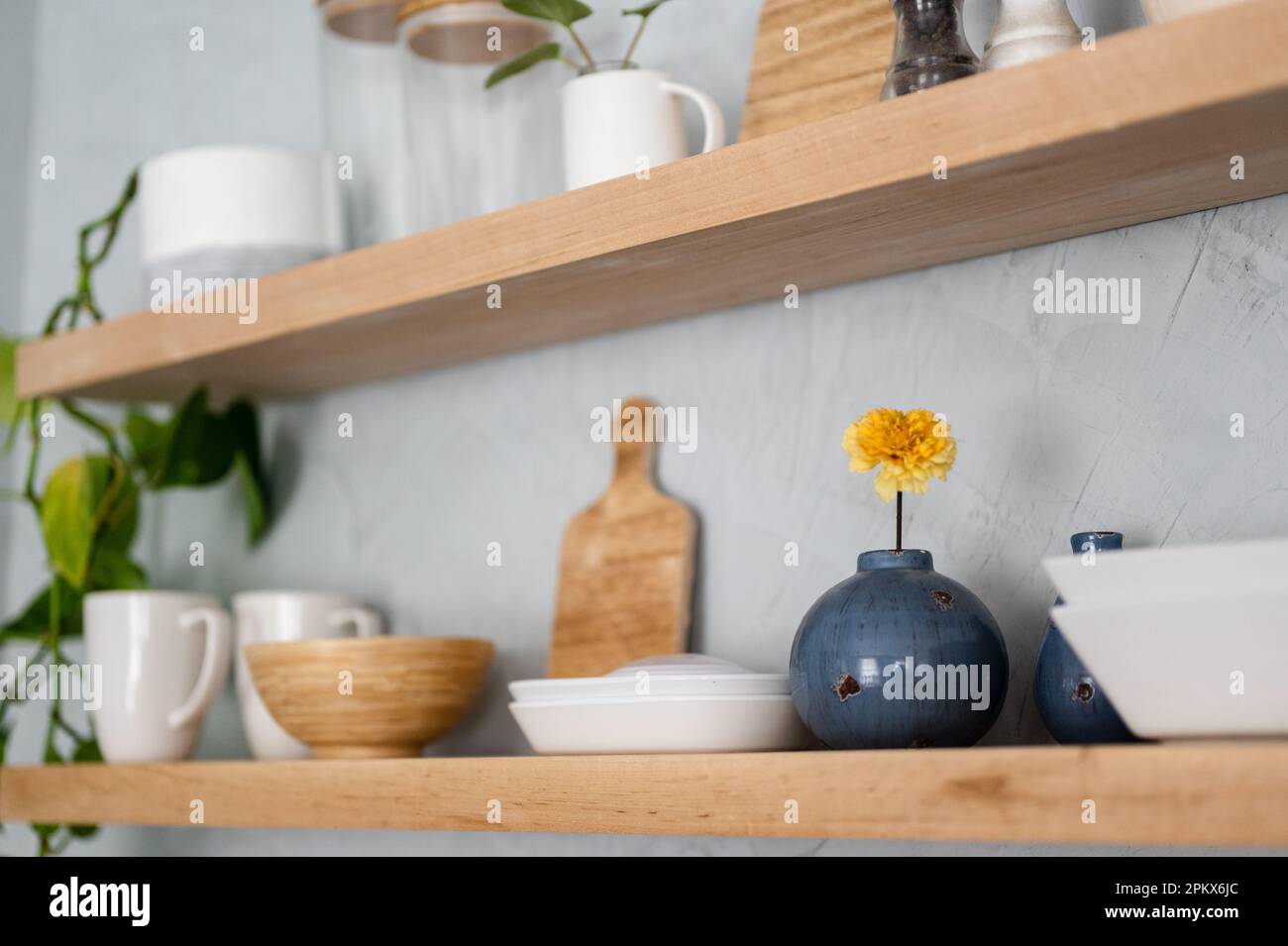 blue vase and kitchen items on modern wood shelf on plaster wall Stock ...
