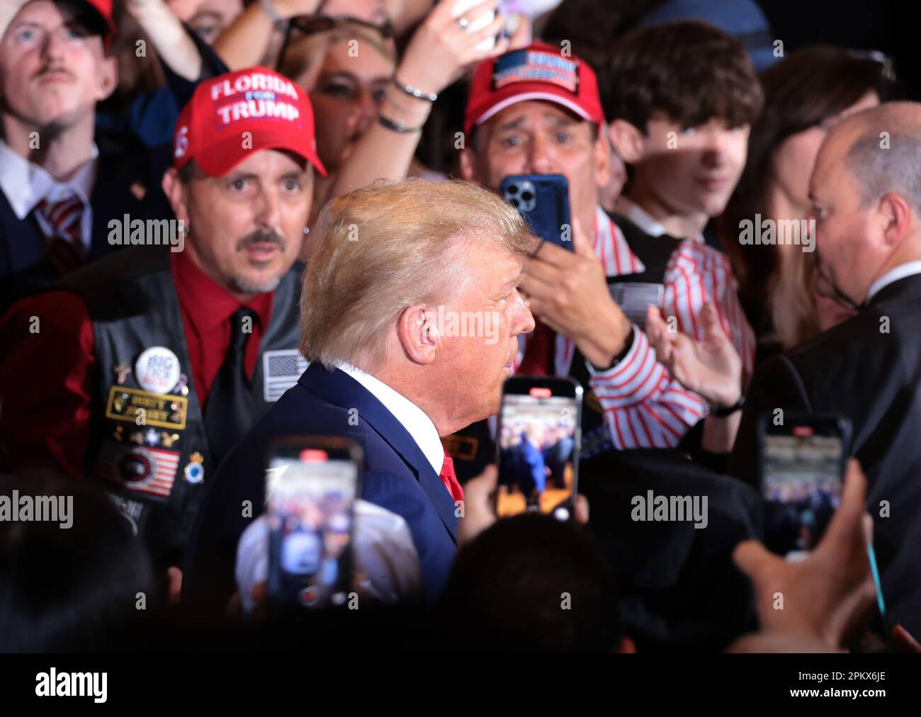 A high-angle view of former President Donald Trump in the center of a ...