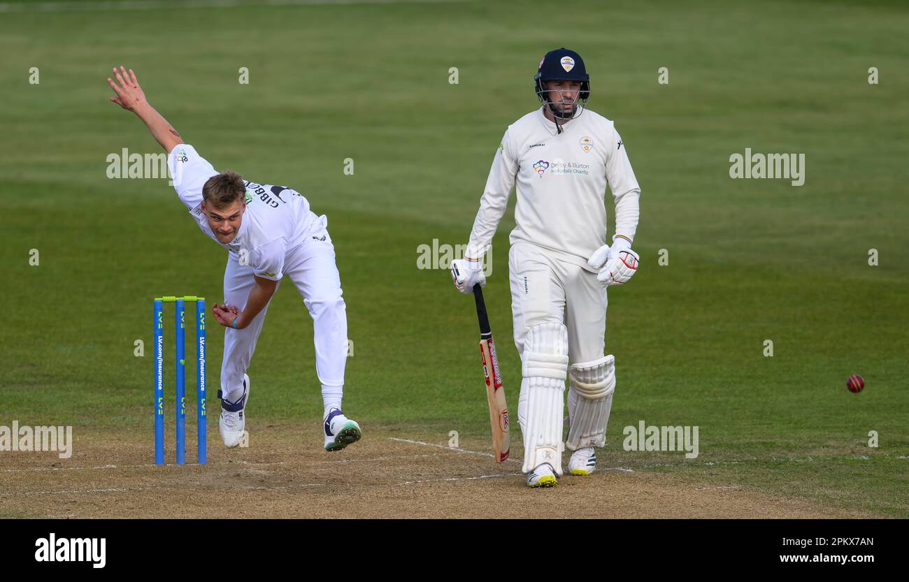 Ben Gibbon bowling for Worcestershire, watched by Derbyshire's Billy ...