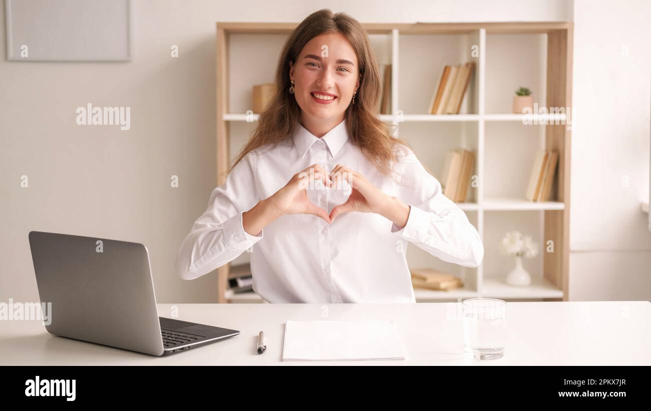 Sending love office woman inspired work smiling Stock Photo - Alamy