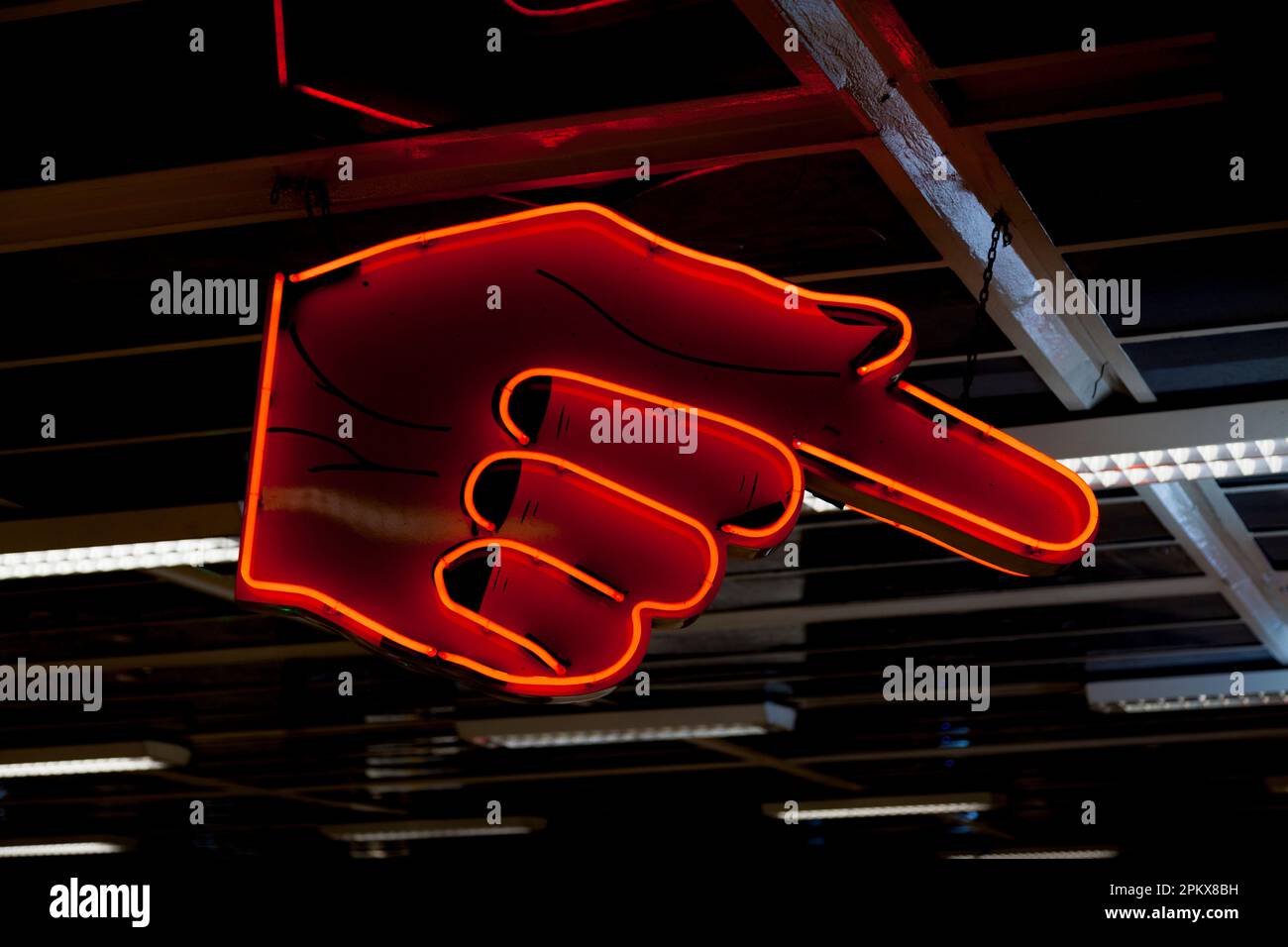 Red neon light shaped like a pointing finger Stock Photo - Alamy