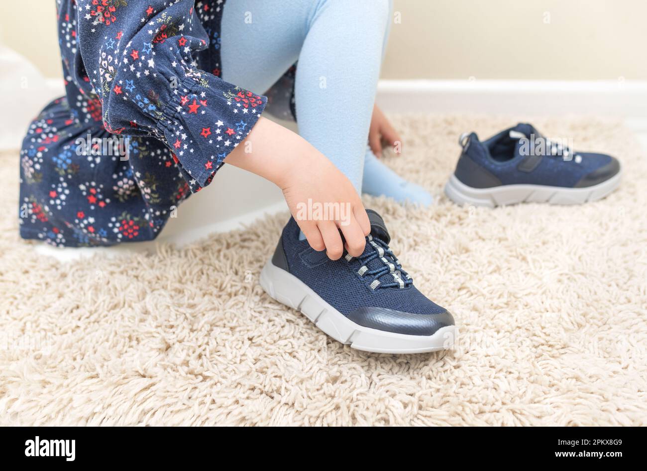The child takes off his sneakers Stock Photo - Alamy
