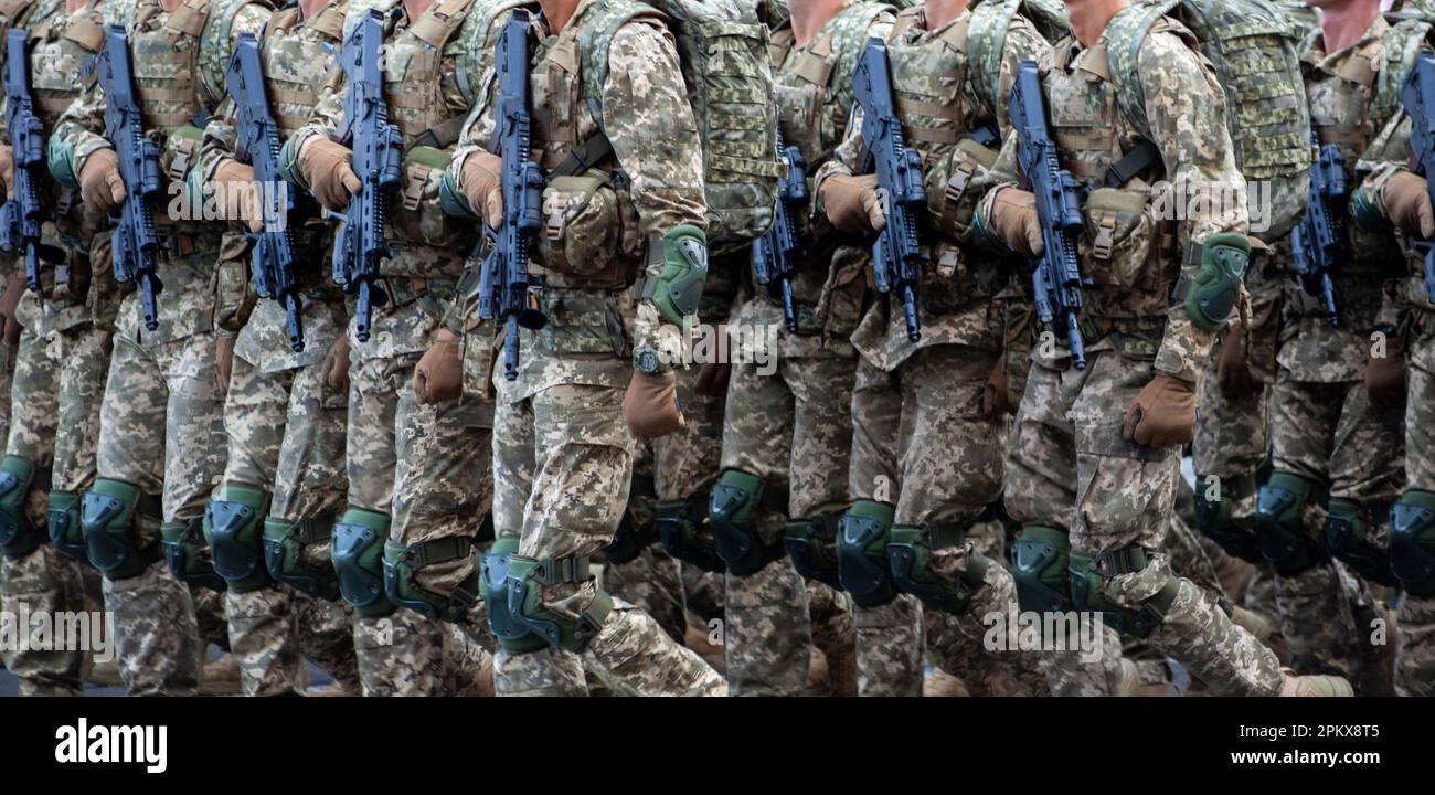 Military soldiers march in a parade with weapons. Pixel uniform ...