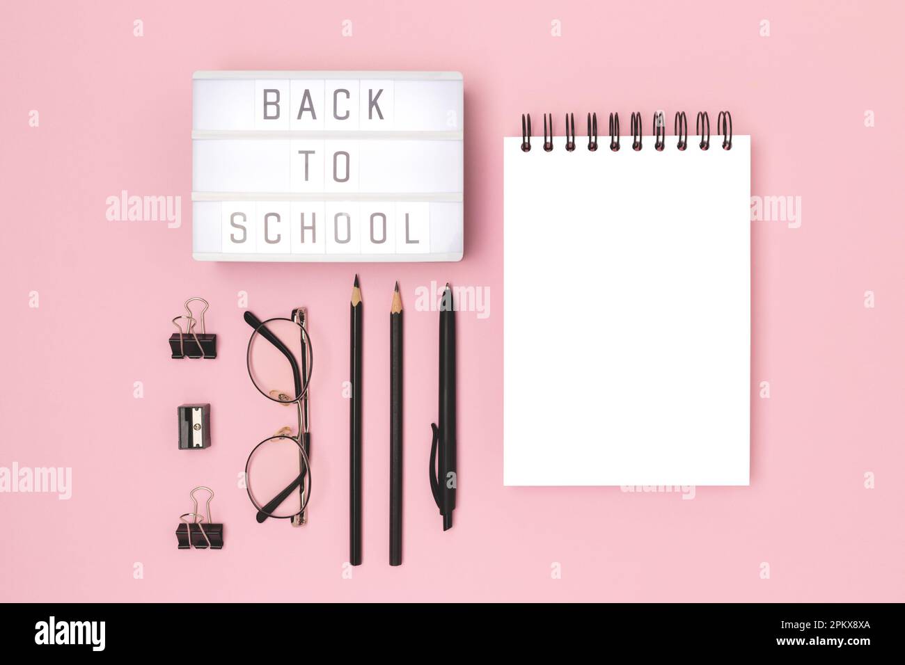 Back to school. Lightbox with letters and black colored stationery on a ...