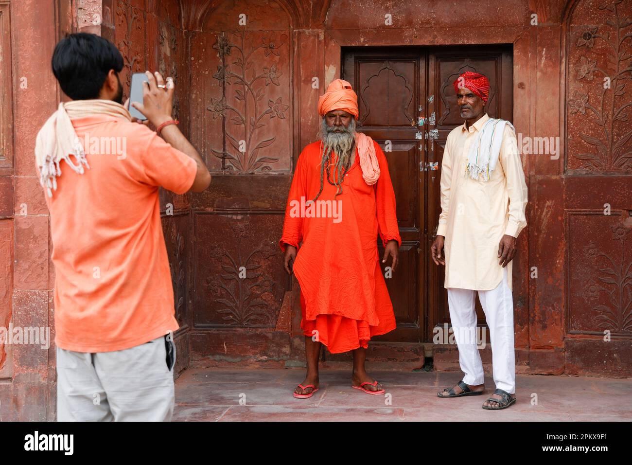 Young man takes a photo of two old Indian men in the Diwan-i-Am ,Red ...