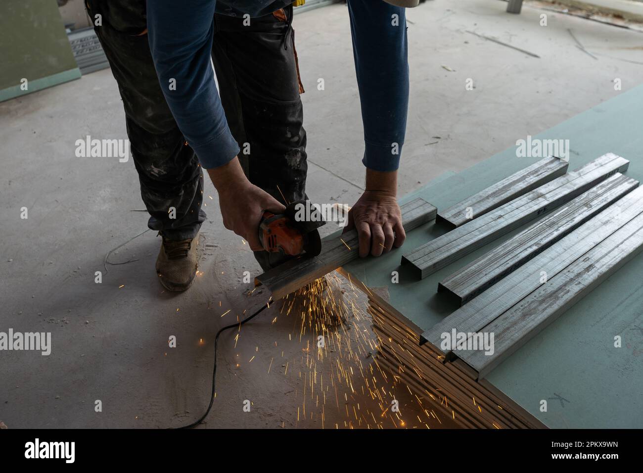 Construction worker installation ceiling work Stock Photo - Alamy
