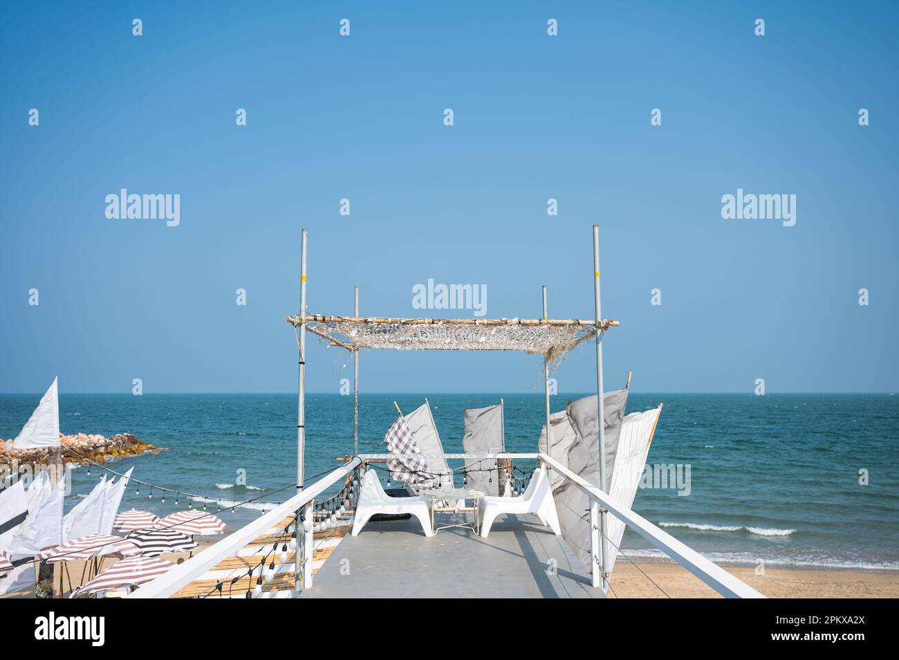 White dining table under the canopy of relax corner on terrace at ...