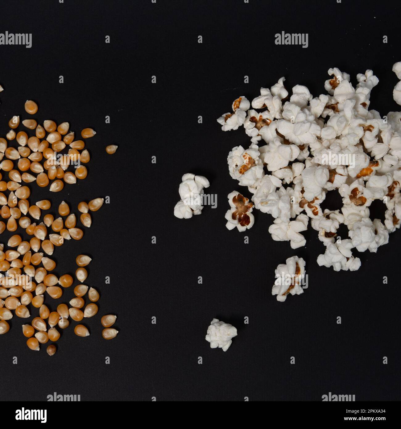Two piles of popcorn, one pile of ready-made popcorn, another with corn ...
