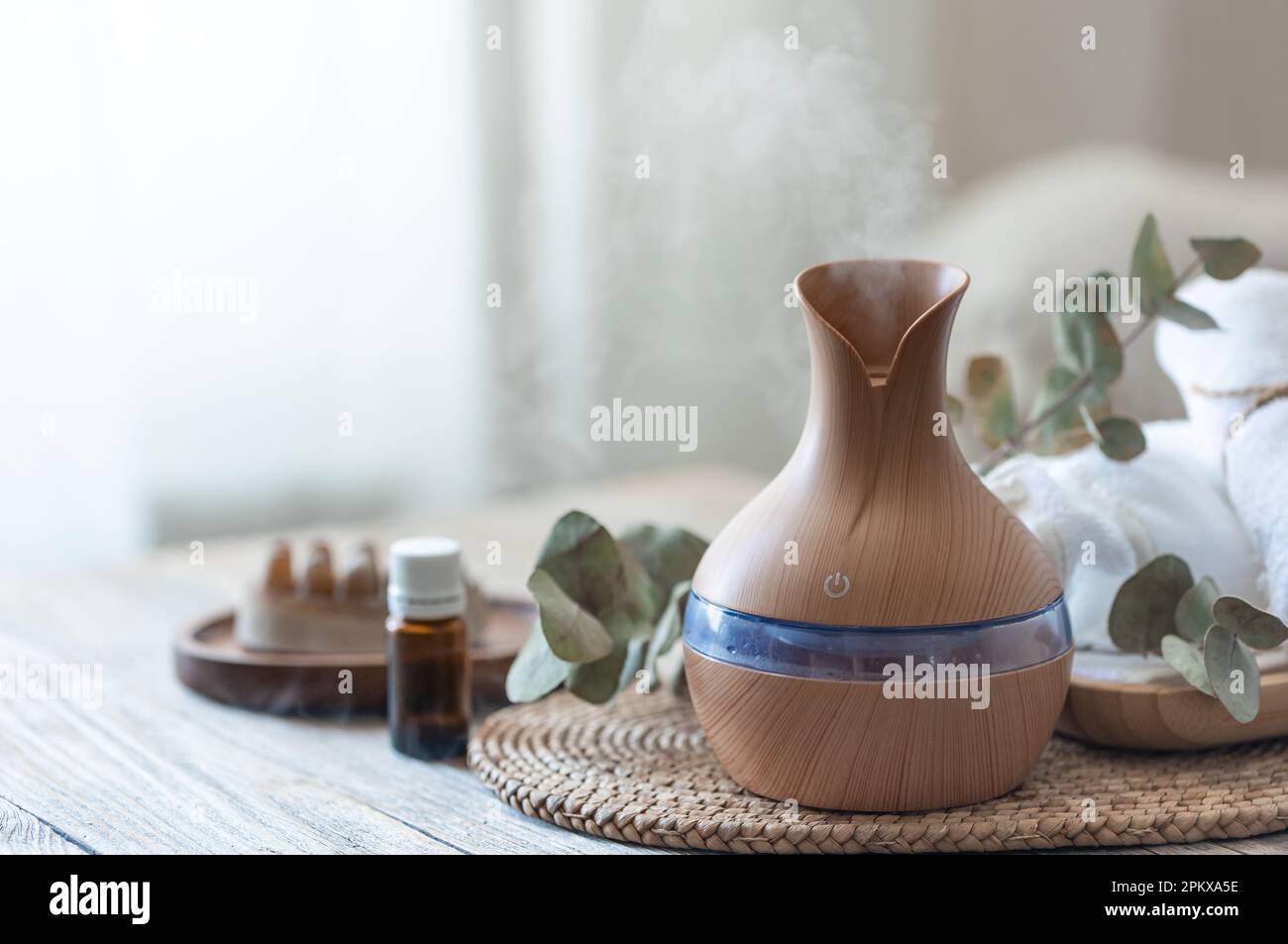 Spa composition with aroma oil diffuser lamp on a blurred background ...