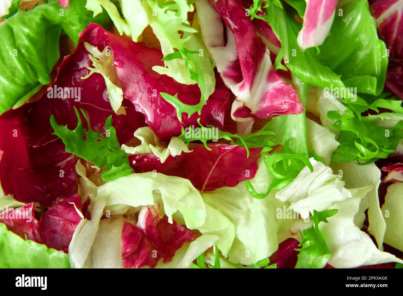 Fresh mixed salad field greens piled closeup top view. Various ...