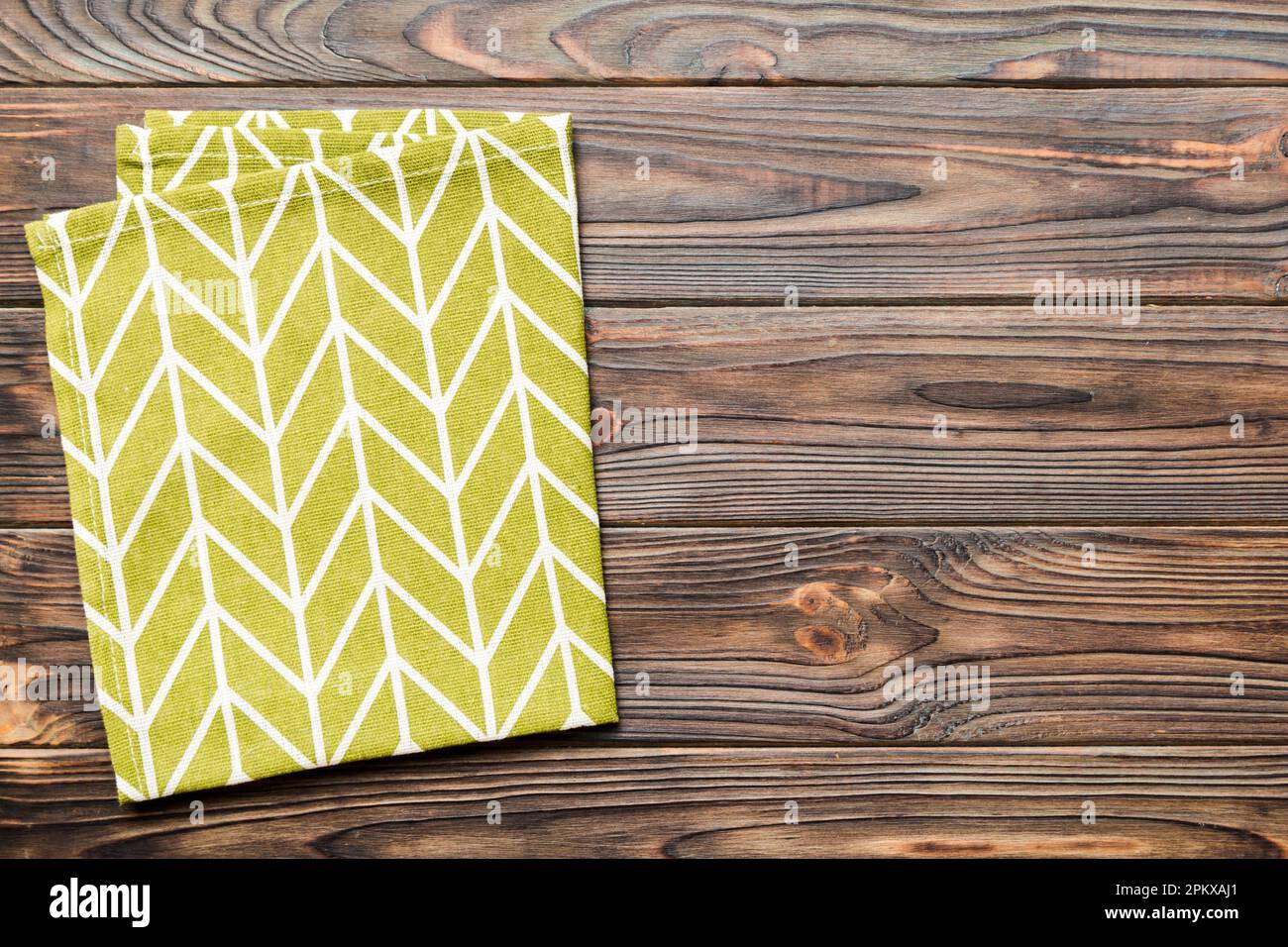 top view with green kitchen napkin isolated on table background. Folded ...