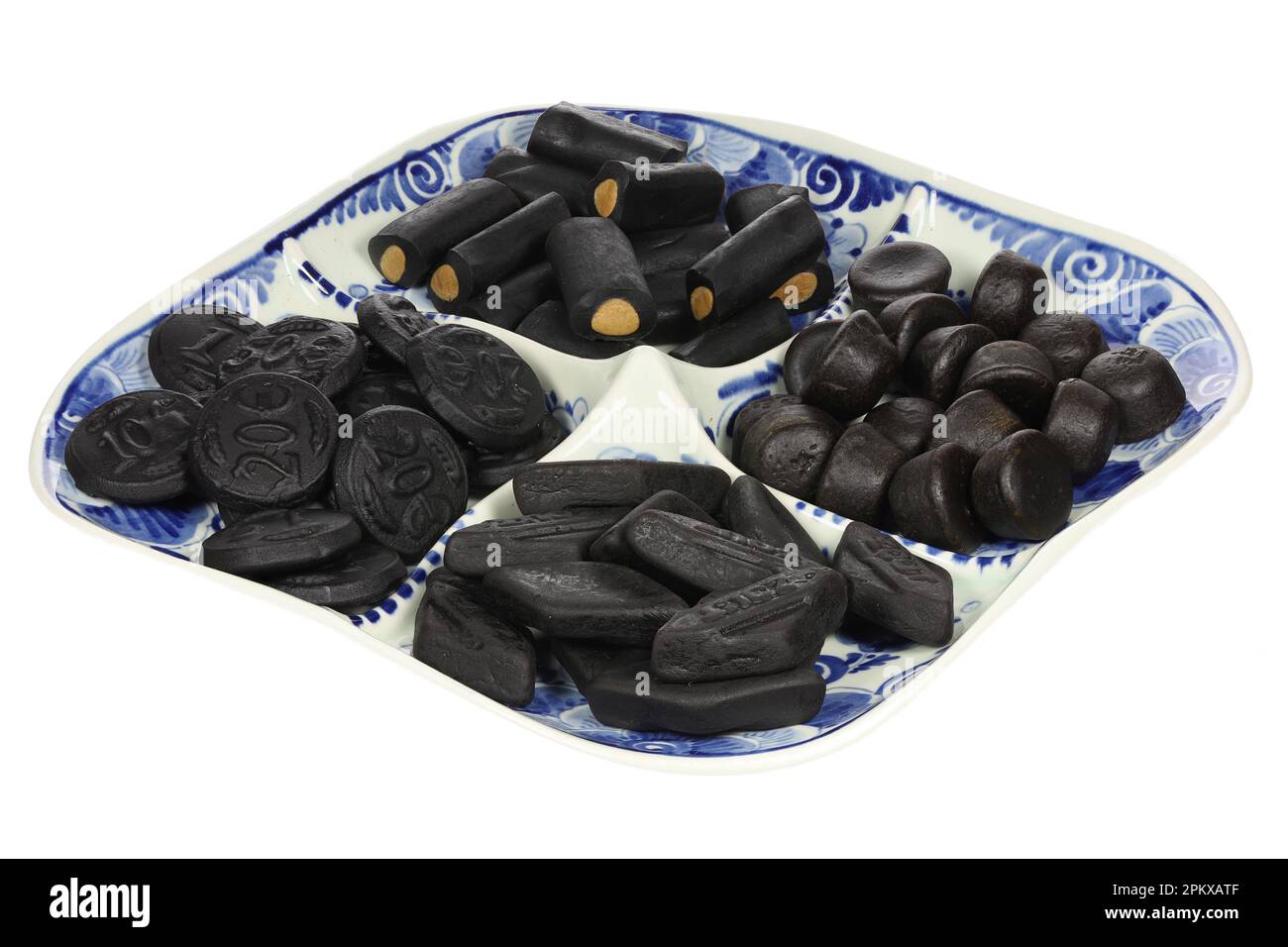Dutch licorice candies on a Delftware plate isolated on white ...