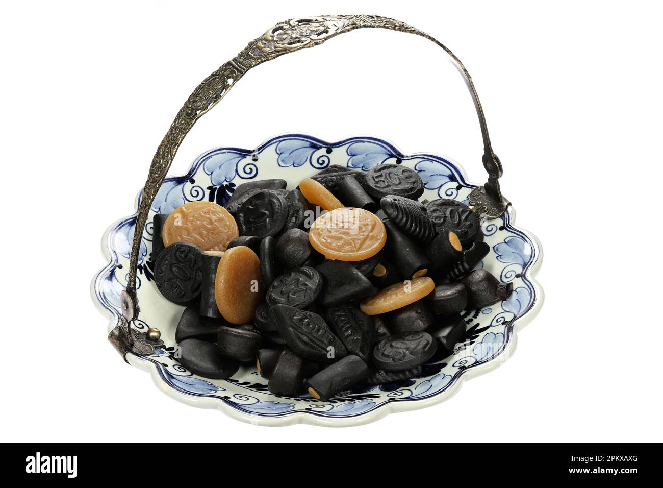Dutch licorice candies on a Delftware plate isolated on white ...