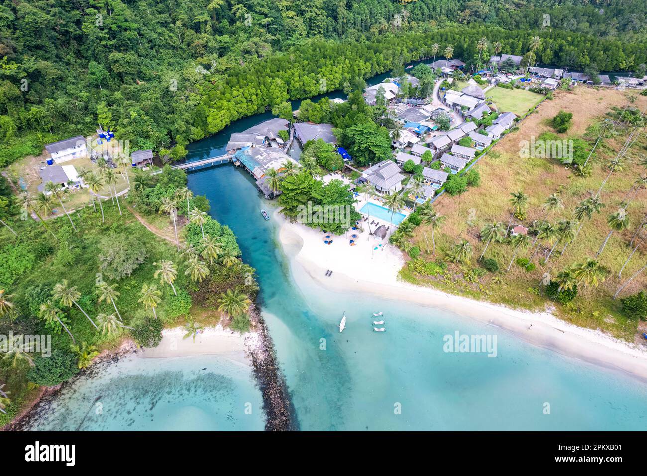 Aerial view of beautiful tropical resort on the beach by mangrove forest in turquioise sea at ...