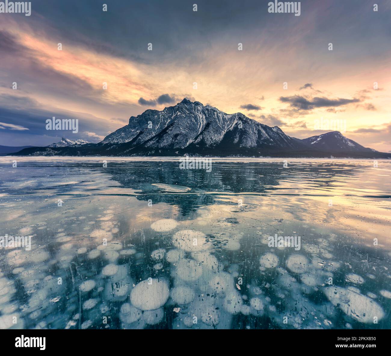 beautiful view of Frozen Abraham Lake with rocky mountains and natural ...