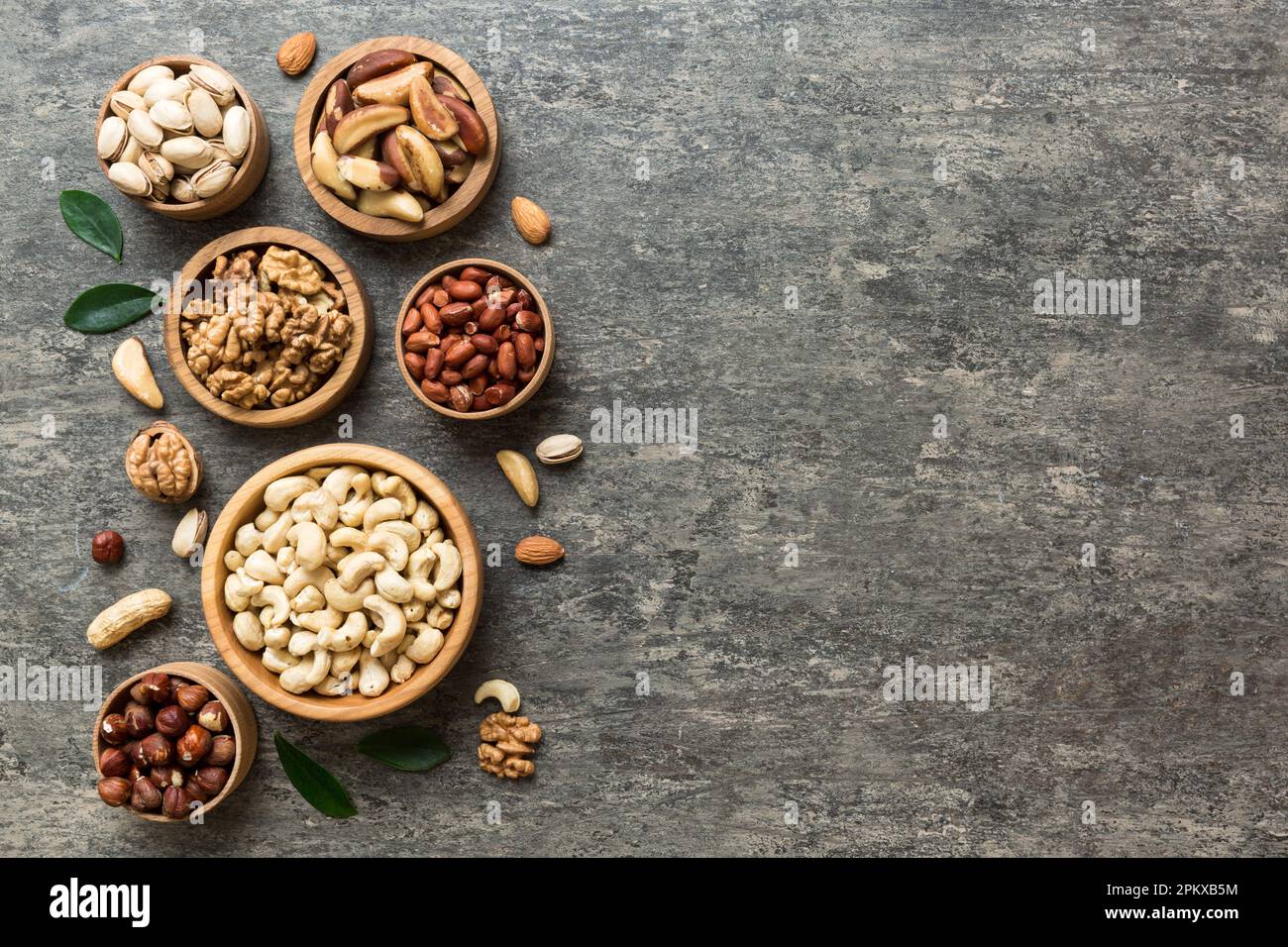 mixed nuts in wooden bowl. Mix of various nuts on colored background ...