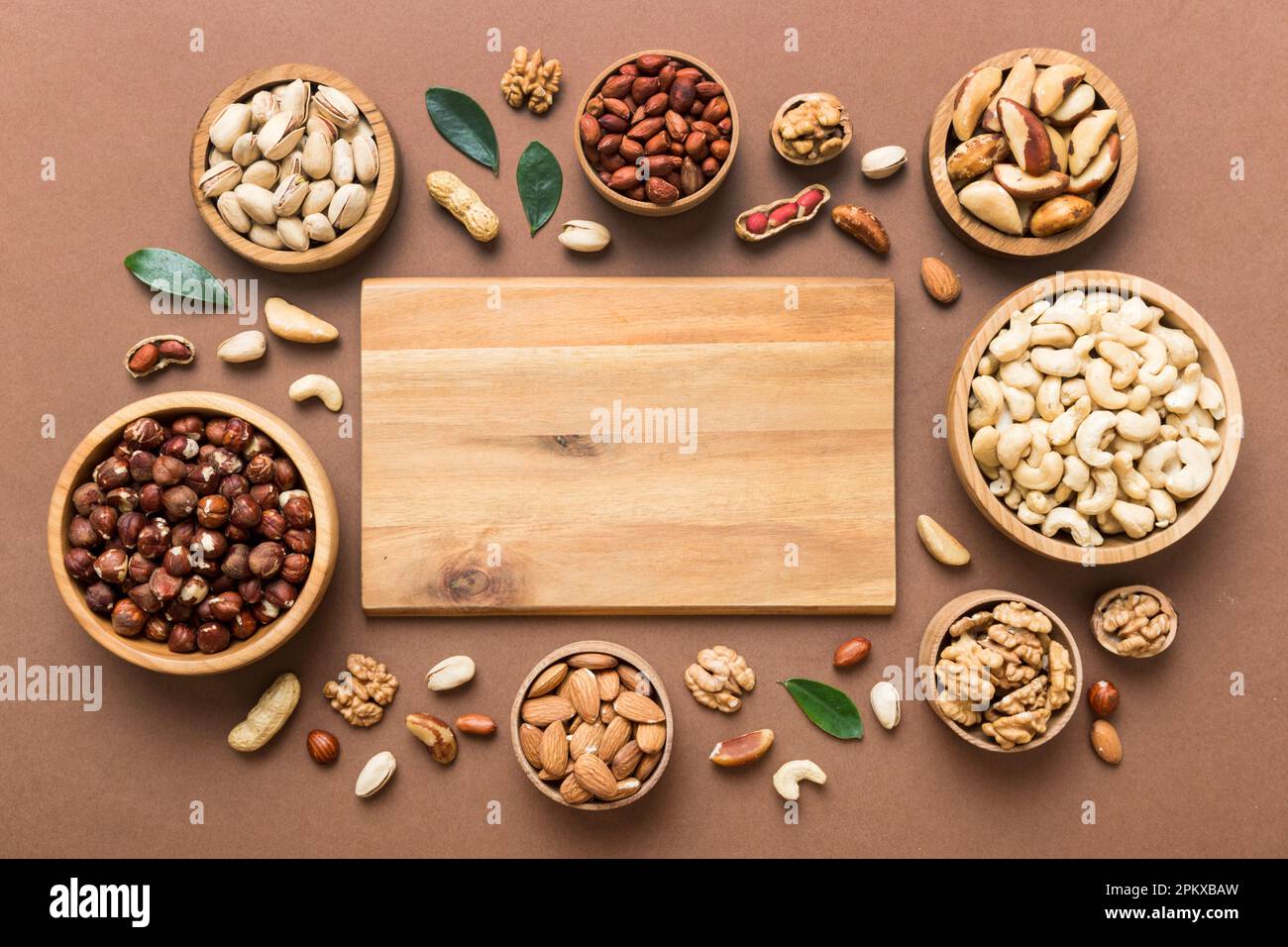 mixed nuts in wooden bowl. Mix of various nuts on colored background ...