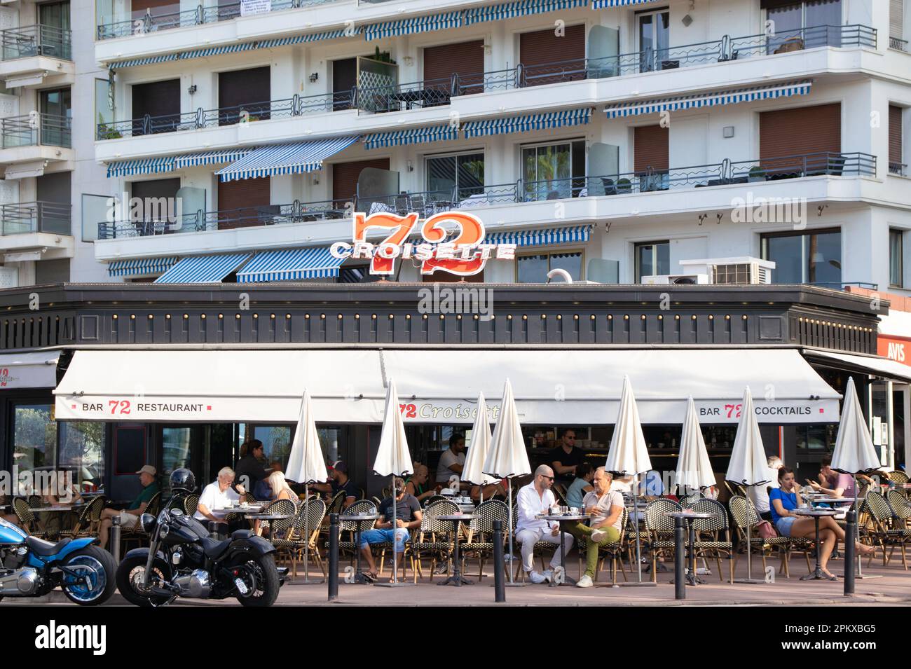 People sit at the pavement tables at 72 Croisette, a corner bar and restaurant on La Croisette ...