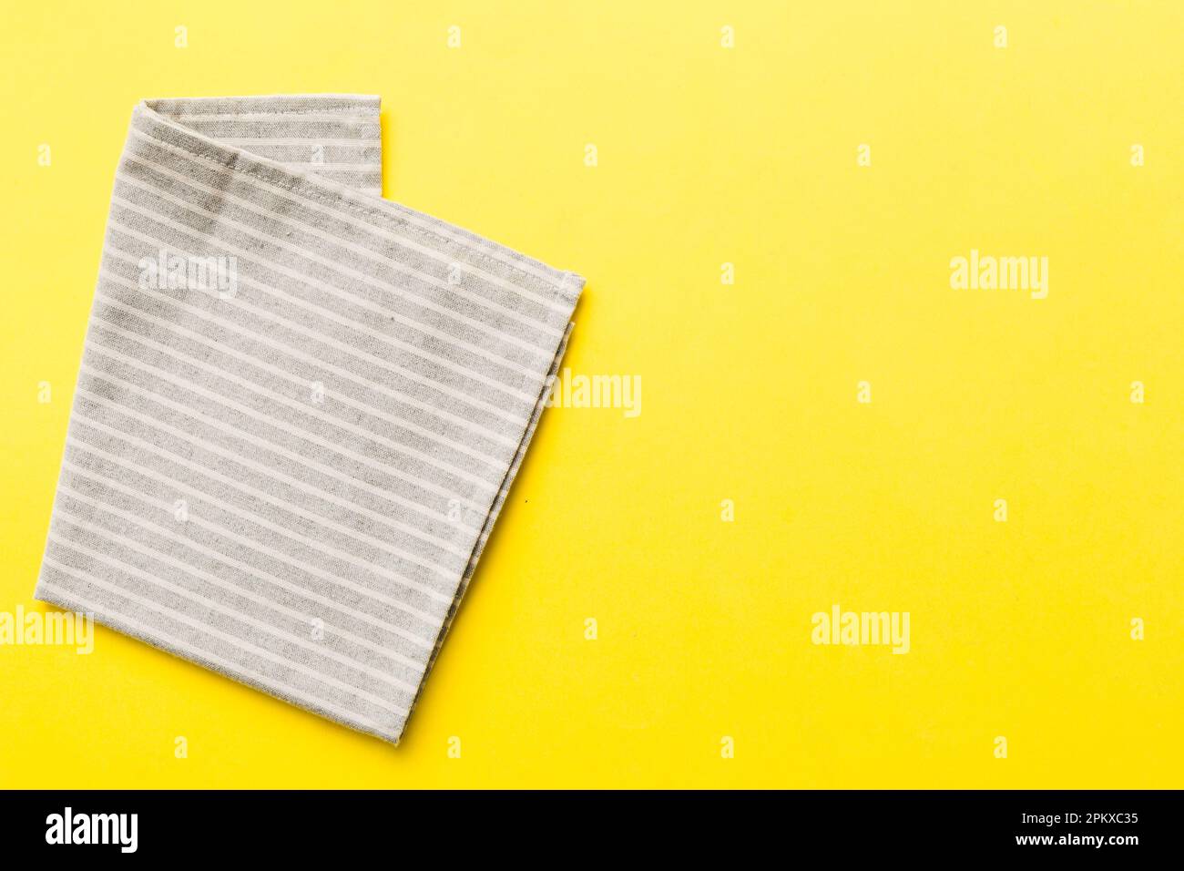 top view with gray kitchen napkin isolated on table background. Folded ...
