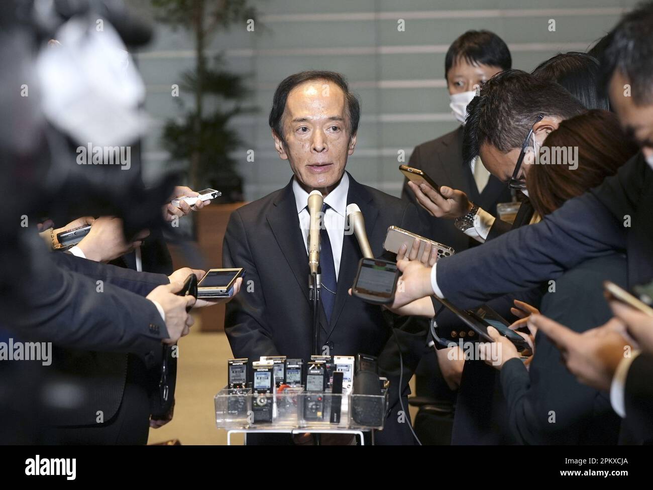 New Bank of Japan Governor Kazuo Ueda speaks to reporters after holding ...