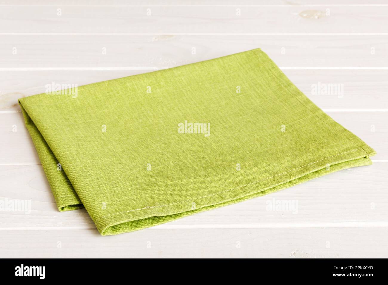 top view with green kitchen napkin isolated on table background. Folded ...