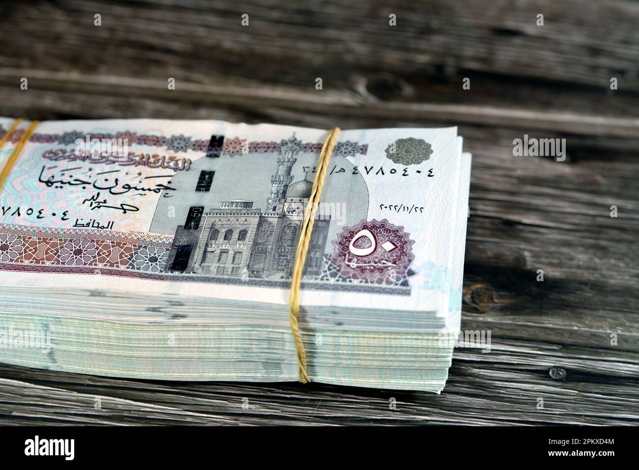 Egypt money stack of pounds isolated on wood background, pile of 50 EGP ...