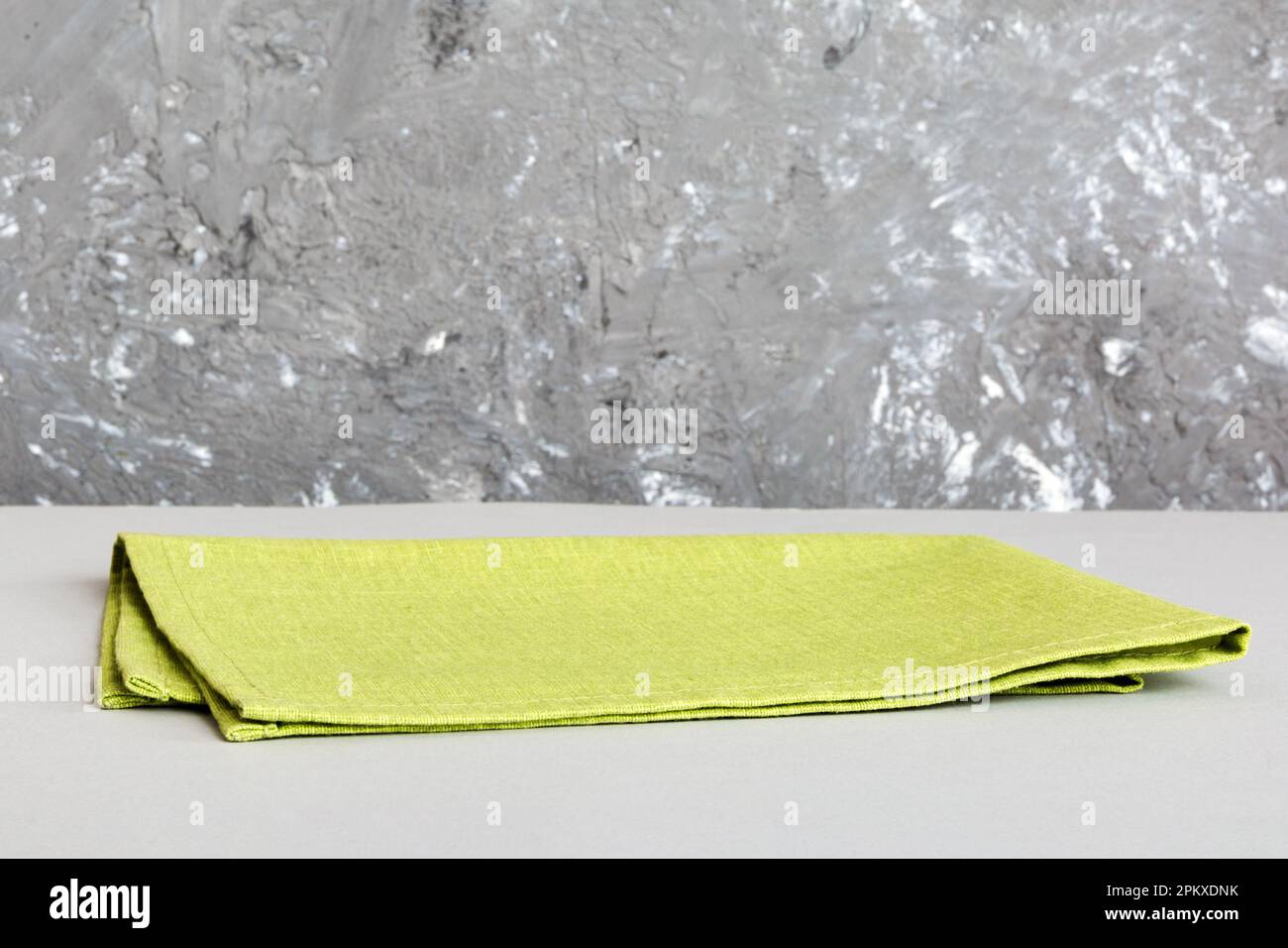 top view with green kitchen napkin isolated on table background. Folded ...
