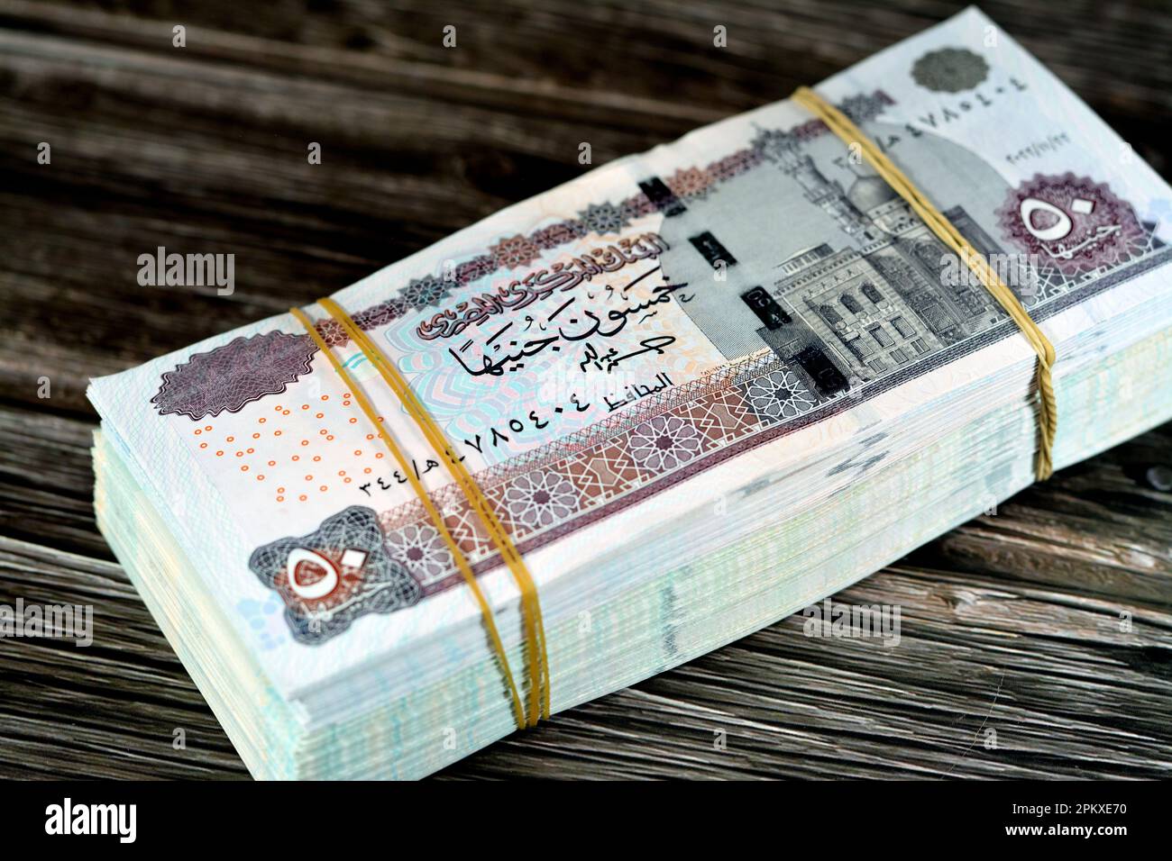 Egypt money stack of pounds isolated on wood background, pile of 50 EGP ...