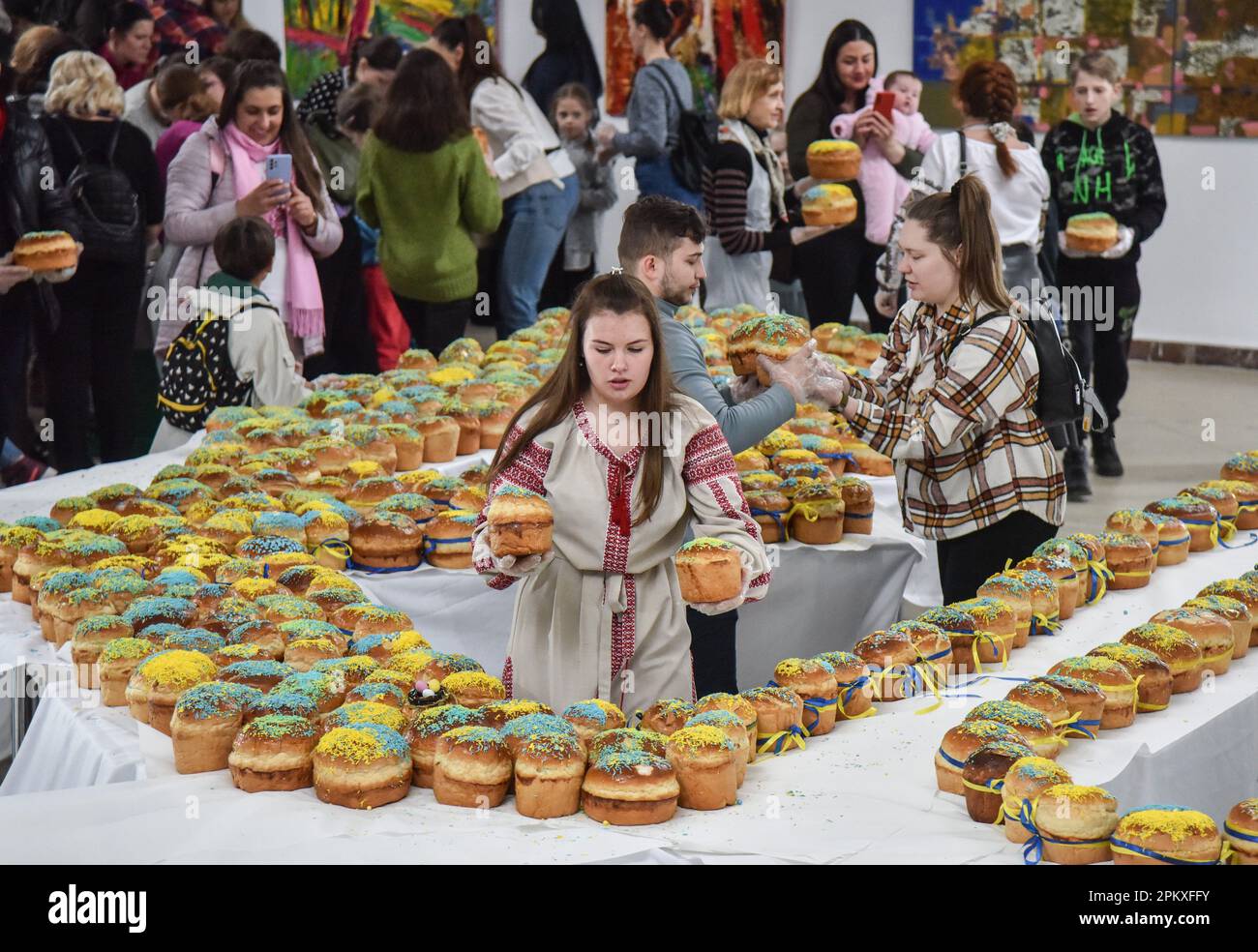 A girl lays out traditional Ukrainian Easter cakes on special tables to ...