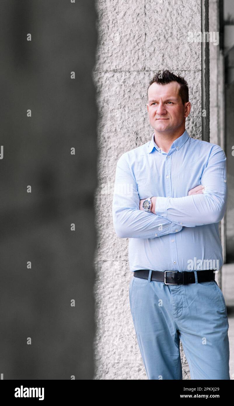 Confident business man standing in the city, looking and dreaming of ...