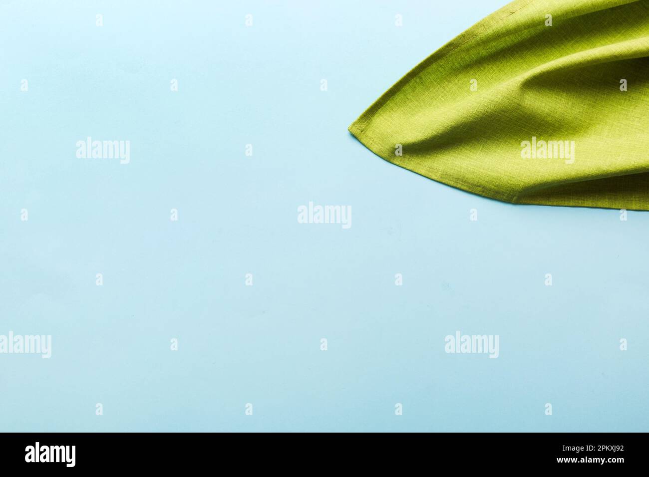 top view with green kitchen napkin isolated on table background. Folded ...