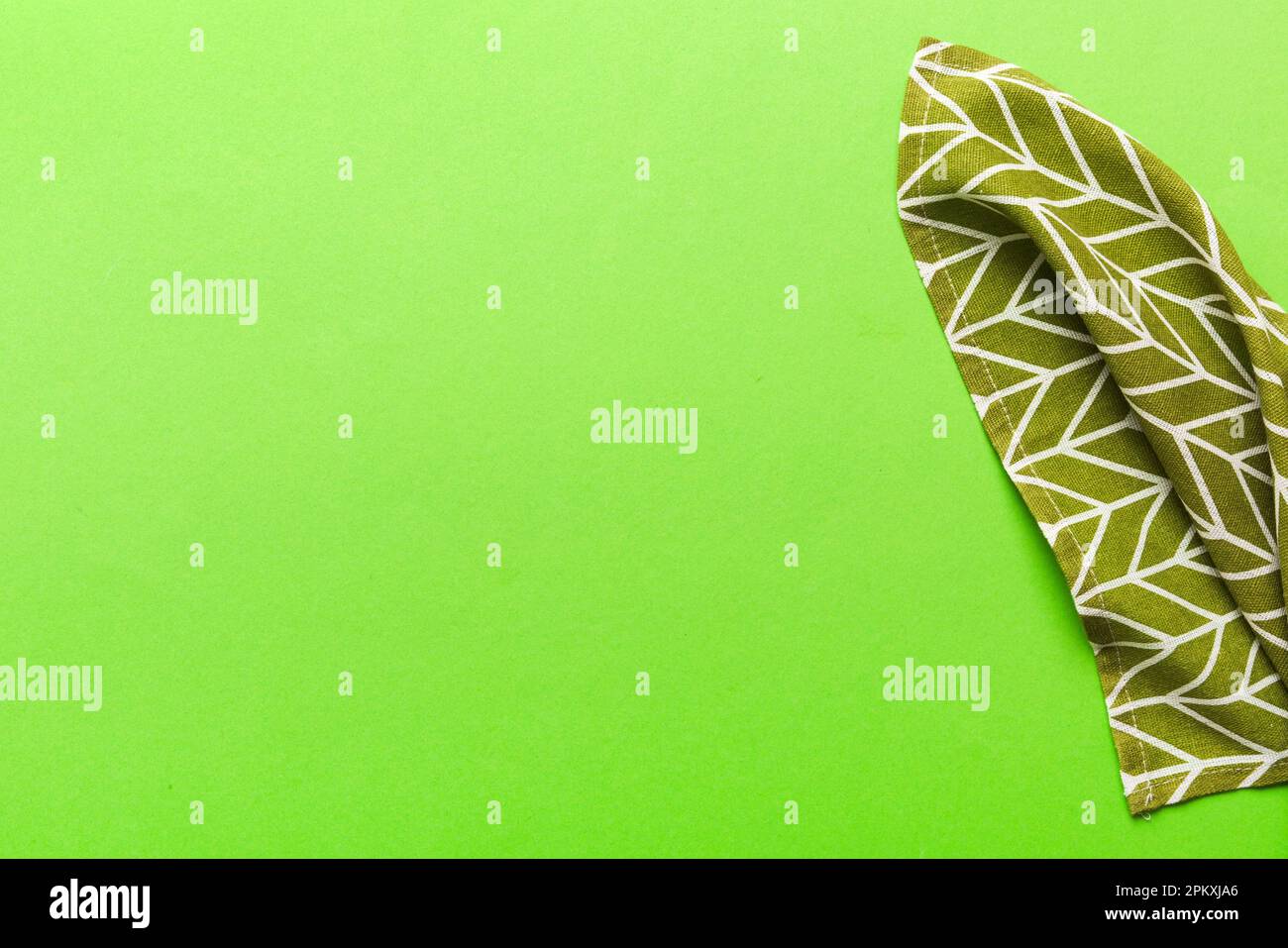 top view with green kitchen napkin isolated on table background. Folded ...