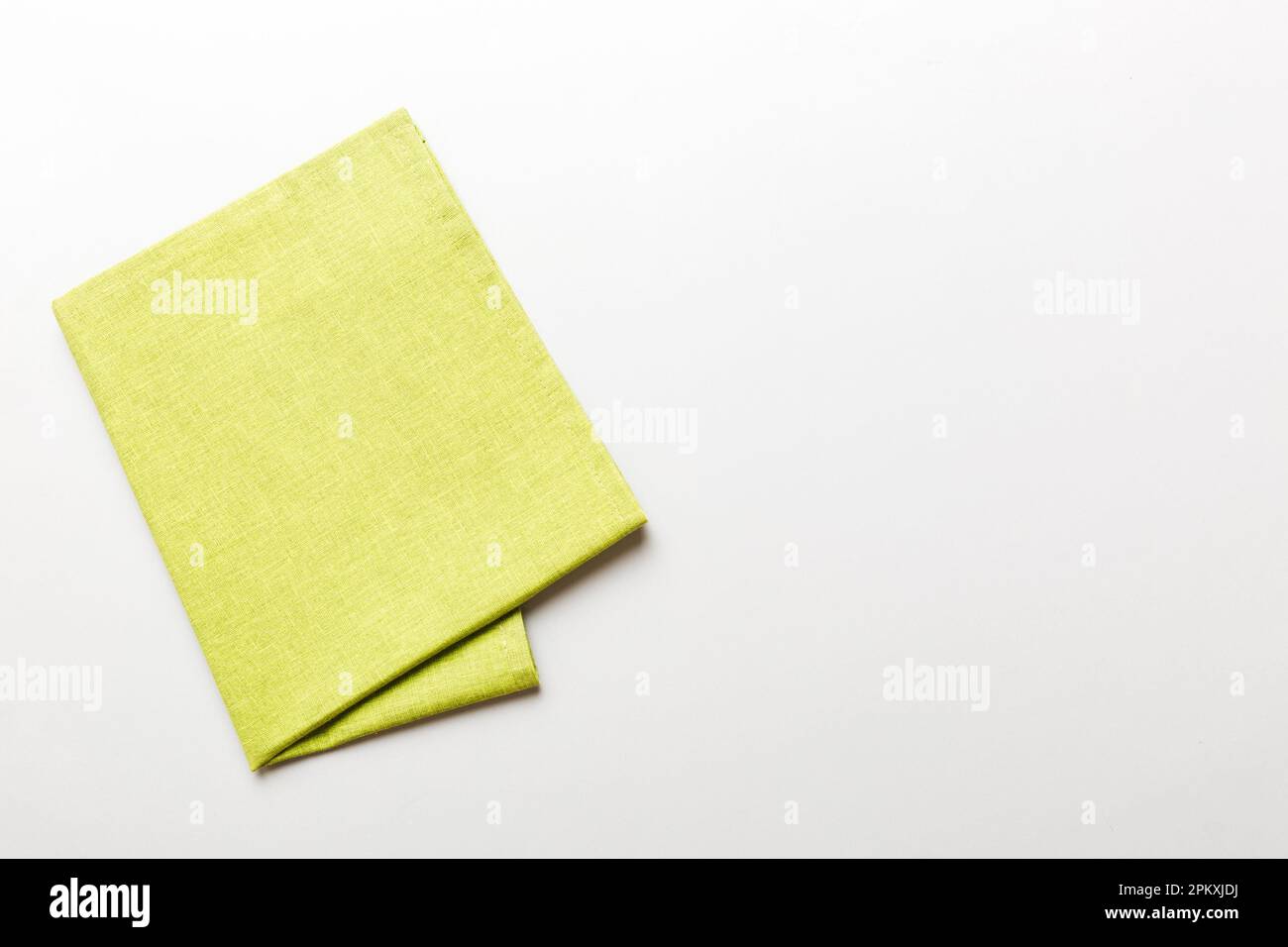 top view with green kitchen napkin isolated on table background. Folded ...